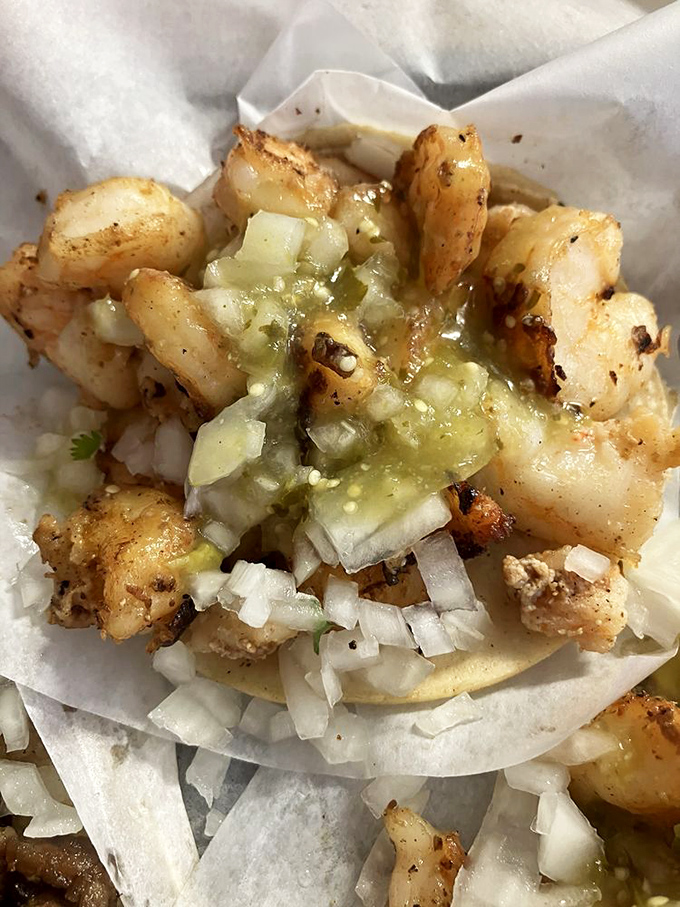 Golden shrimp tacos topped with vibrant green salsa – proof that the ocean meets Mexico beautifully here.