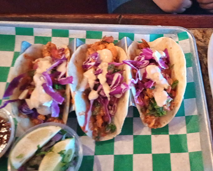 These tacos aren't just colorful — they're a flavor fiesta. Purple cabbage, creamy sauce, and perfectly seasoned shrimp come together like edible art on a checkered tray.