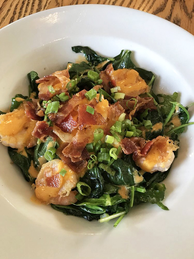Shrimp nestled on a bed of greens with bacon crumbles and green onions—proof that healthy-ish eating doesn't have to be a punishment.
