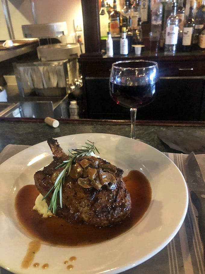 A pork chop so magnificent it makes you wonder if some pigs are just born destined for greatness. The rosemary garnish isn't decoration—it's a crown.