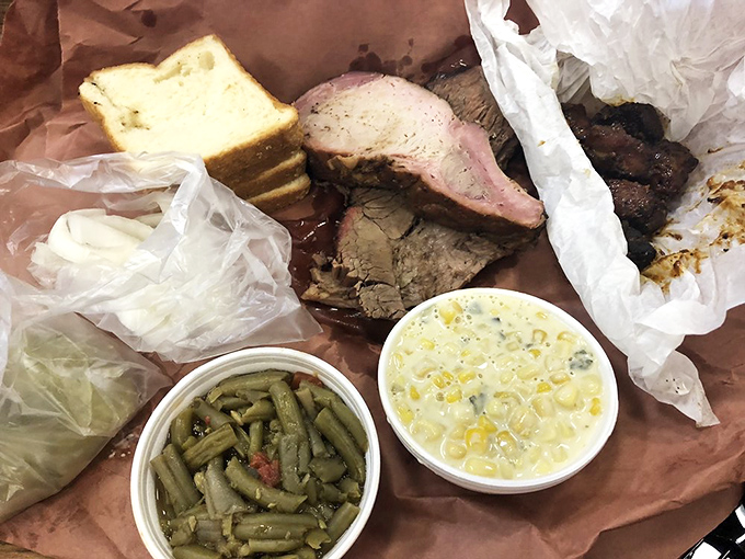 Smoke-kissed meat nestled in humble butcher paper—proof that the best dining experiences often come without fancy china or pretension.