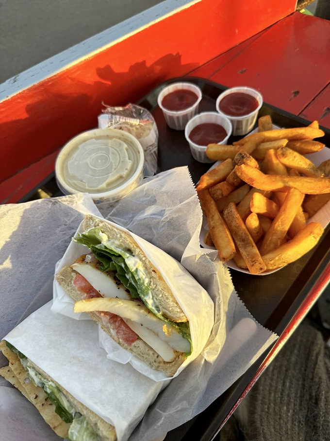Fresh seafood sandwich wrapped in paper – nature's perfect to-go package. Add cold lemonade and suddenly Monday feels like a vacation day.