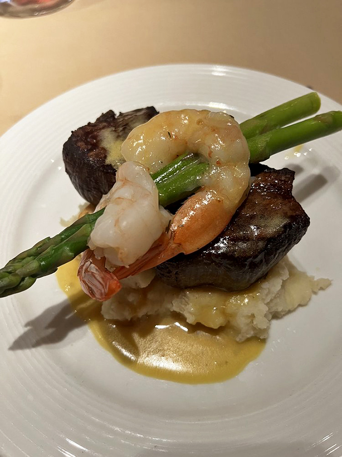The Steak Christopher is culinary architecture at its finest—filet mignon foundation, shrimp crown, and that béarnaise sauce river flowing beneath it all.