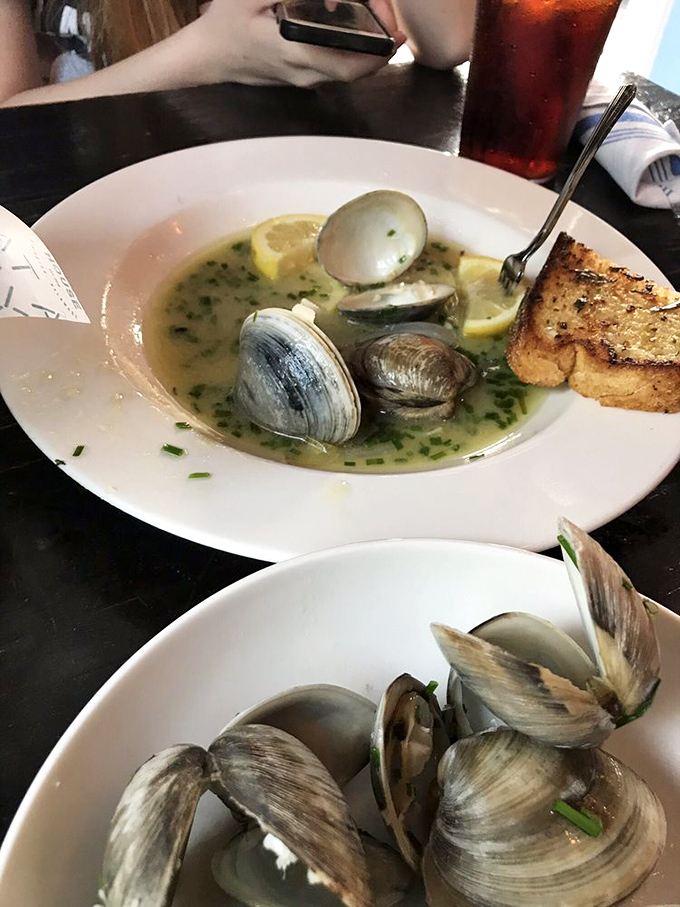 Steamer clams swimming in buttery broth with a side of toasted bread for dipping – Neptune's idea of the perfect comfort food on a plate.