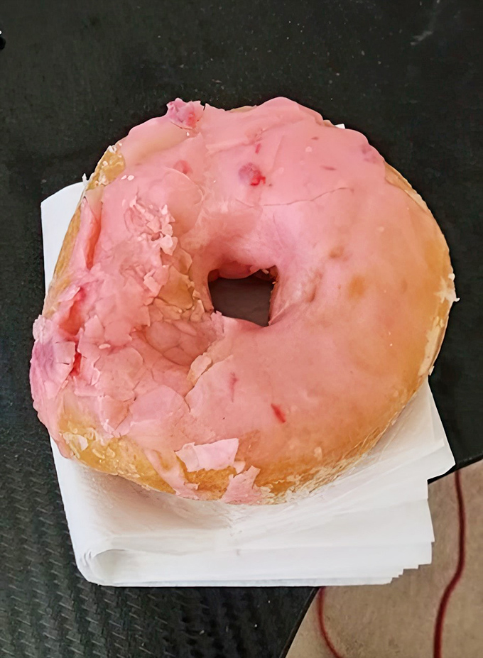 The strawberry donut wears its pink frosting like a badge of honor—crackly, sweet, and unapologetically old-school in the best possible way.