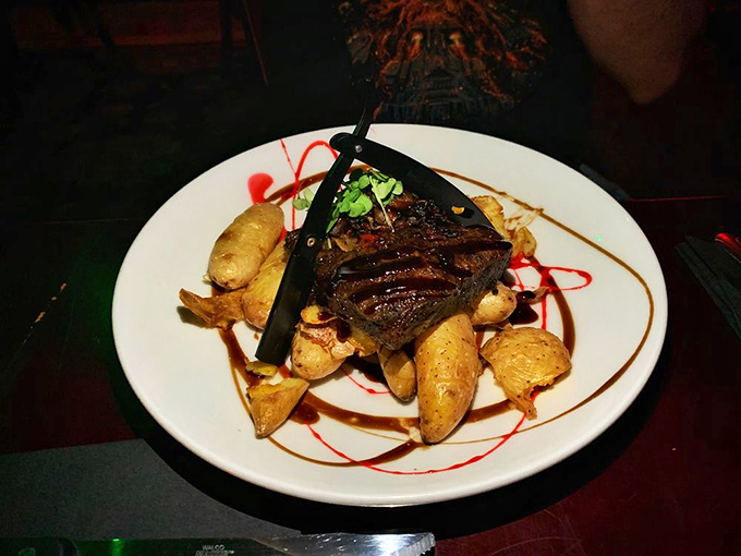 This steak isn't just cooked—it's dramatically presented with artistic sauce flourishes and potatoes that could have been carved by Sweeney Todd himself.
