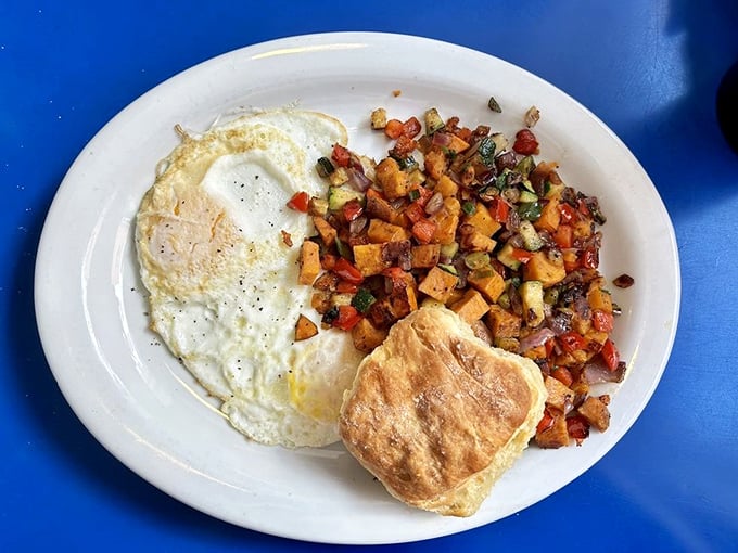 Breakfast reimagined: sunny-side up eggs alongside a colorful sweet potato hash that turns "morning fuel" into something worth setting an alarm for.