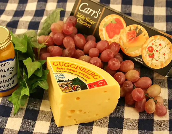 Guggisberg Baby Swiss with grapes and crackers—the holy trinity of snacking. This cheese board isn't just a meal, it's a statement.