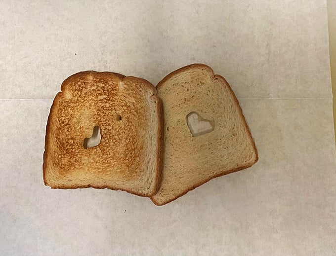 Someone cut hearts into the toast, proving that even in the simplest diners, there's room for love letters written in carbohydrates.