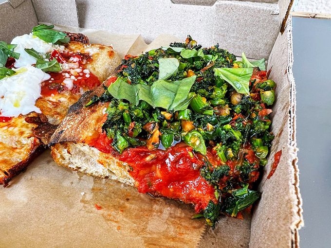 Tomato pie with greens so fresh they practically photosynthesized onto the crust. Garden-to-pizza pipeline at its finest.