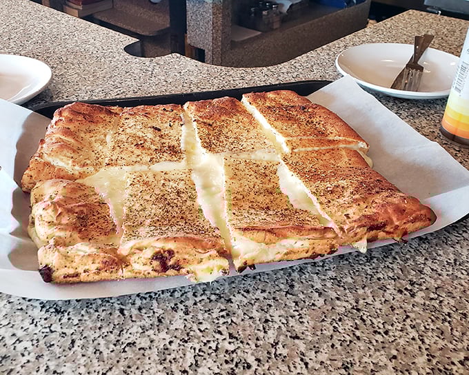 The white pizza arrives like a blank canvas painted with cheese—a masterpiece that would make even the Mona Lisa smile.