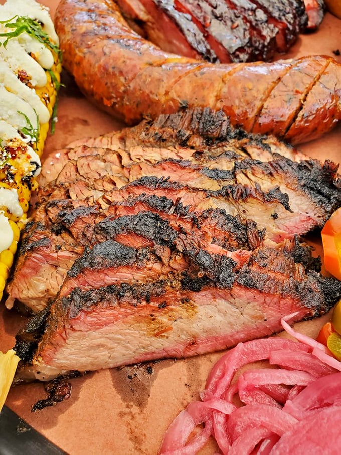 Slices of brisket with that perfect pink smoke ring—like edible jewelry that makes grown adults weep with joy.