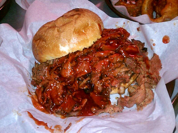 The tri-tip sandwich isn't merely food—it's an architectural marvel of meat and sauce that requires both hands and absolutely zero shame.