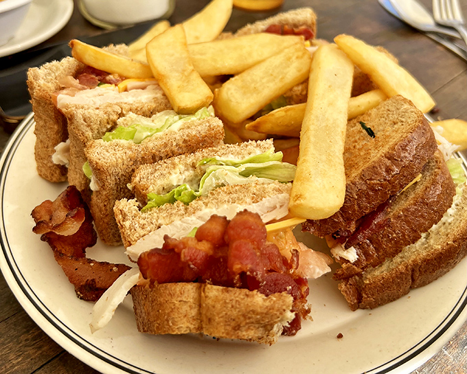 The club sandwich: three layers of proof that sometimes the classics endure because they're simply perfect. Those fries aren't just a side—they're co-stars.