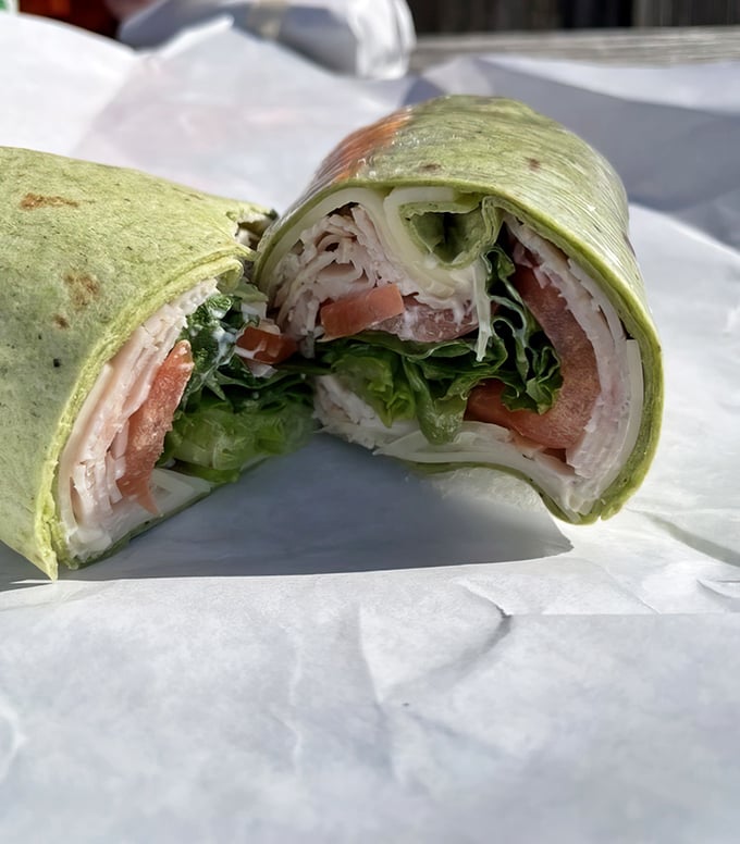 This wrap doesn't just contain turkey—it embraces it, along with crisp veggies in a green tortilla that's the culinary equivalent of a perfect spring day.
