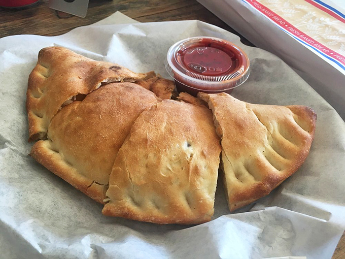 Golden, flaky, and generous – this calzone doesn't understand the concept of skimping. A half-moon of happiness served with marinara on the side.