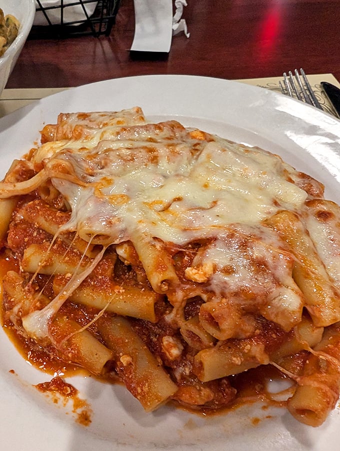 Baked ziti that doesn't mess around—pasta tubes swimming in rich meat sauce under a blanket of melted cheese that stretches with each forkful.