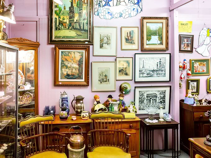 Wall-to-wall nostalgia with framed landscapes and figurines that transform this pink-walled booth into a time capsule of mid-century decorating aspirations. 
