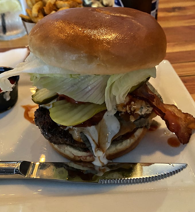 Behold the architectural marvel that is a properly built burger—layers of flavor stacked with the precision of a culinary engineer.