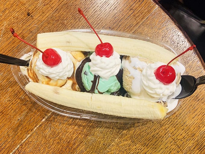 The classic banana split—three scoops nestled in nature's perfect dessert vessel. Proof that sometimes the old ways are still the best ways.