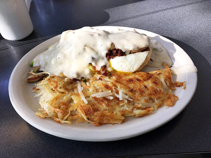 Breakfast nirvana achieved! Golden hash browns with the perfect crisp-to-tender ratio alongside biscuits drowning happily in creamy gravy.