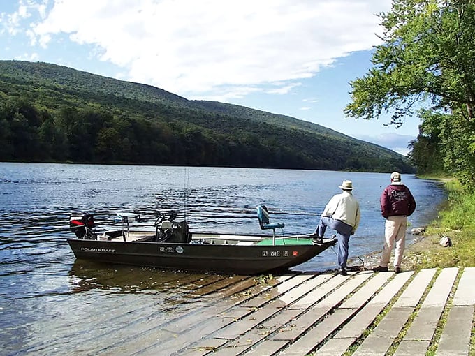 Two anglers prepare for a day on the water, proving that fishing isn't just about catching—it's about standing in places this beautiful while pretending to be patient.