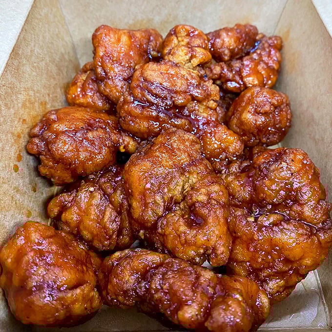 These boneless wings aren't just coated in sauce—they're baptized in it, creating a sticky, sweet, spicy symphony that demands extra napkins.
