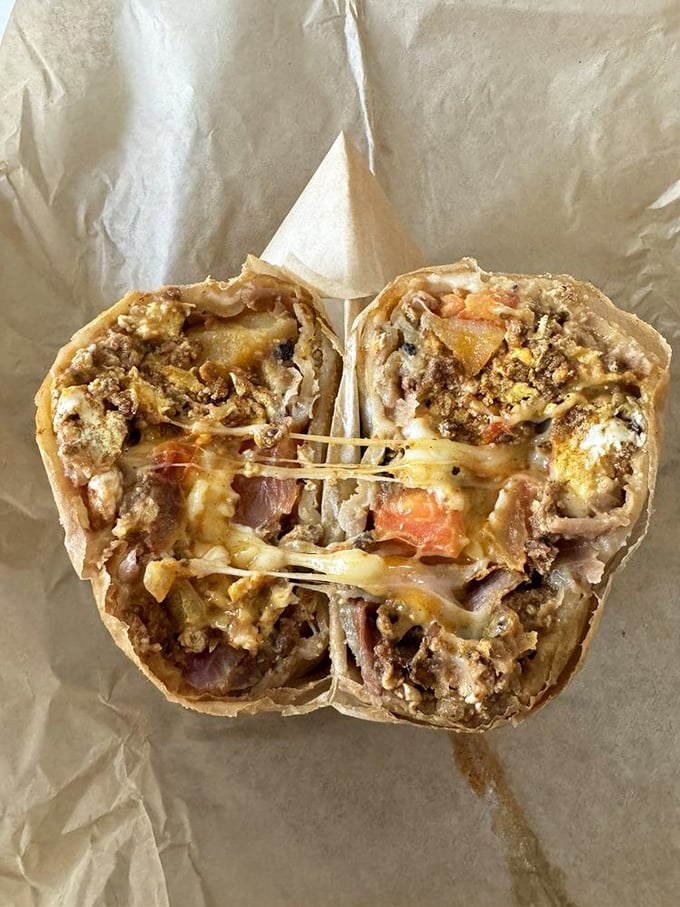 The breakfast burrito cross-section reveals the architectural genius within—layers of flavor held together by melty cheese mortar.