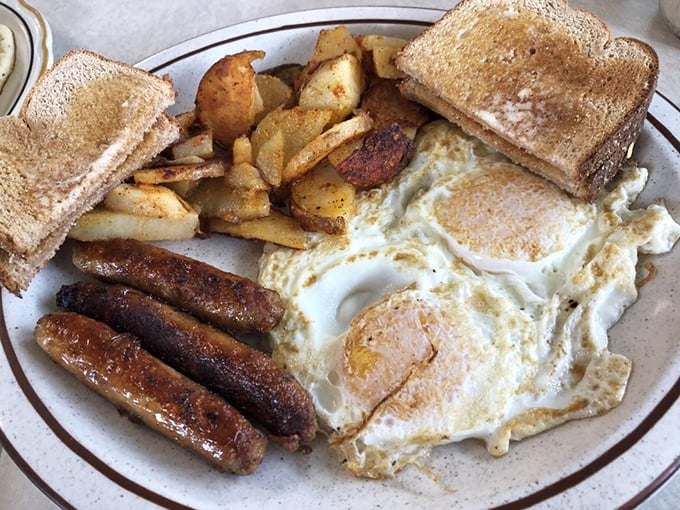 The breakfast trinity: perfectly cooked eggs, sausage links with just the right snap, and home fries that could make a potato proud.