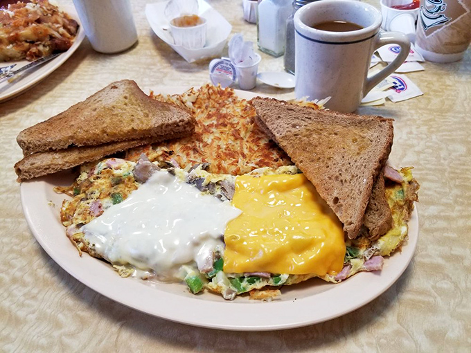 Breakfast doesn't get more honest than this—golden hash browns, perfectly cooked eggs, and toast standing by for yolk-sopping duty. Coffee mandatory.