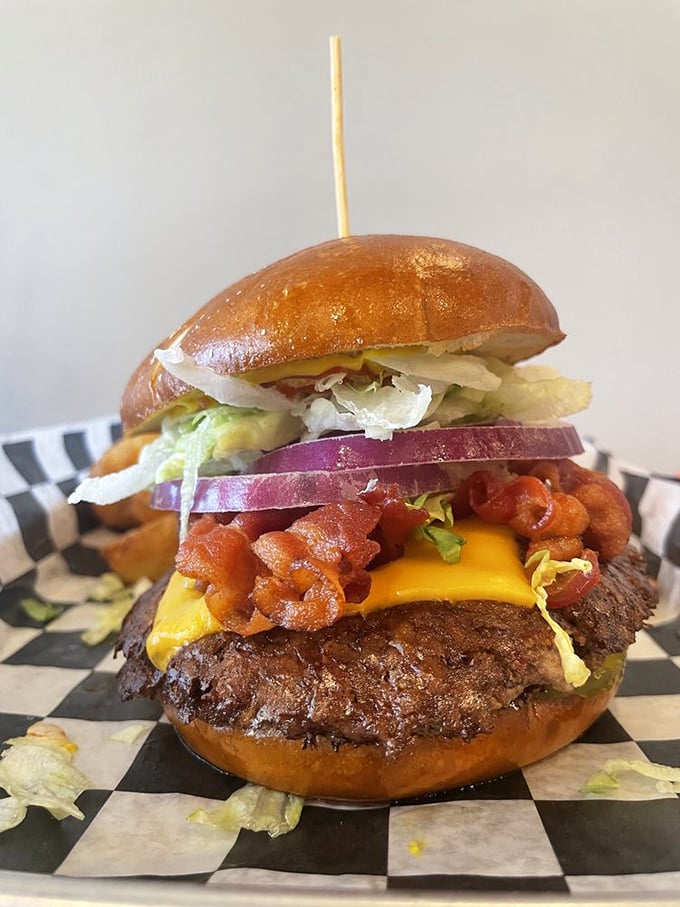 A burger that requires both hands and a strategy. That brioche bun is holding more treasures than Fort Knox.
