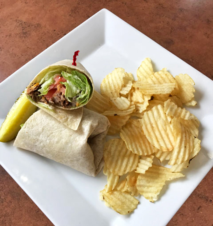 This isn't just a wrap—it's breakfast's answer to a hug, bundled with care and served with chips that crunch like morning optimism.