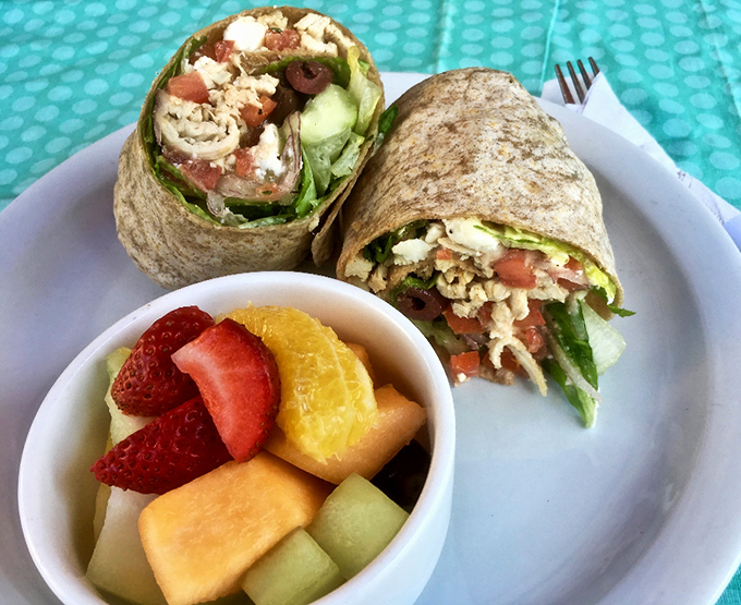 This isn't just a wrap – it's a morning fiesta bundled in a tortilla, with fresh fruit playing the perfect supporting role.