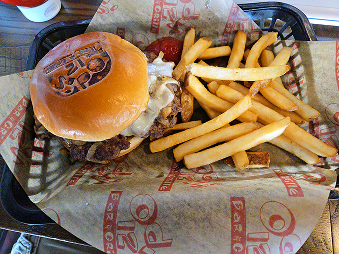 A burger that demands to be photographed before eaten. The branded bun is like the restaurant signing its delicious masterpiece.