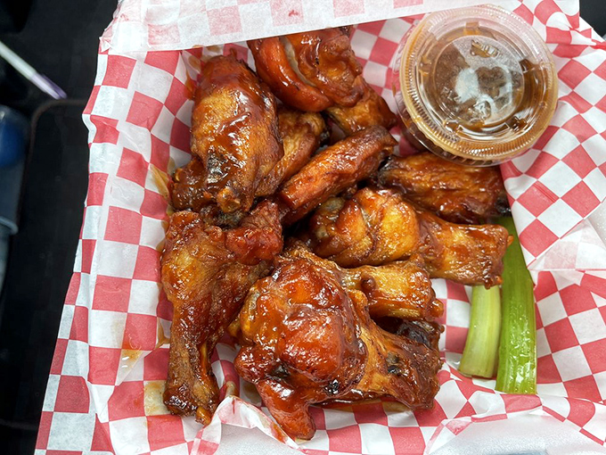 These wings aren't playing around – glazed to sticky perfection and arranged like a delicious mosaic on that classic red-checkered paper.