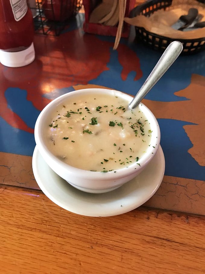 The clam chowder arrives like a warm, creamy hug in a bowl—chunks of clam hiding in a velvety sea, waiting to comfort you after a tough day of beach lounging.