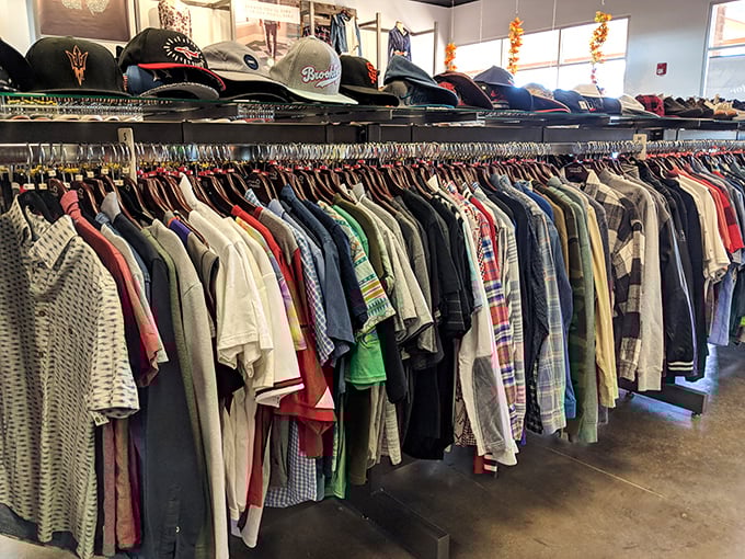 Men's shirts lined up like eager job applicants—each one promising to make you look more put-together than you actually are.