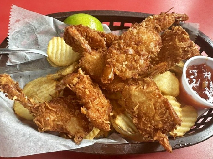 Golden-fried coconut shrimp that crunch like a satisfying beach day, served with a dipping sauce worth bottling and taking home.