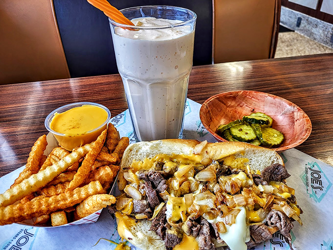The holy trinity of Philly dining: a perfectly grilled cheesesteak, crispy crinkle-cut fries, and a milkshake thick enough to stand a spoon in.