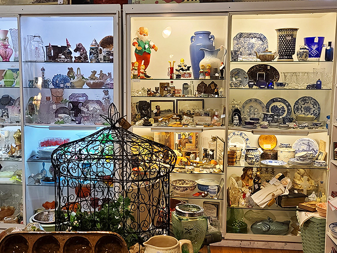 Behind glass doors, carefully curated collections of china, figurines, and glassware create a museum-like display of everyday elegance from bygone eras.