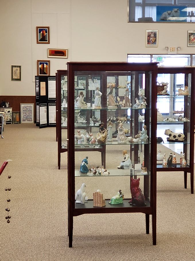 Elegant display cases house porcelain cat figurines that would make any collector's whiskers twitch with envy.