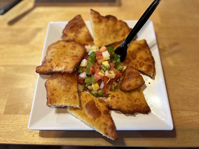 Whoever decided to arrange homemade fried bread around fresh salsa deserves a Nobel Prize for culinary genius – it's Florida innovation at its finest.