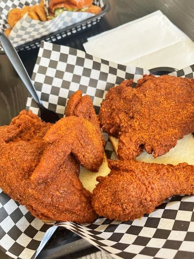 Nashville-style hot chicken with a crust so perfect it should be in a museum. That red coating isn't just color—it's a promise.