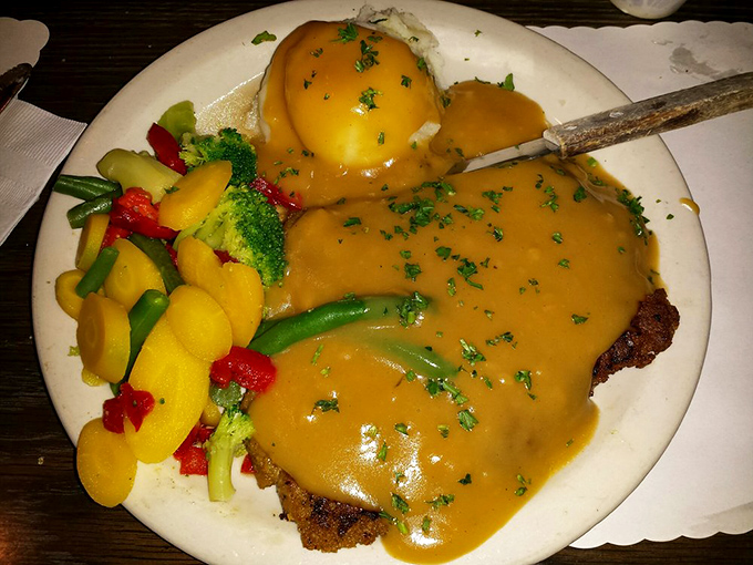Country fried steak swimming in gravy—where comfort food meets California fresh. Those colorful vegetables aren't just for show; they're delicious co-conspirators.