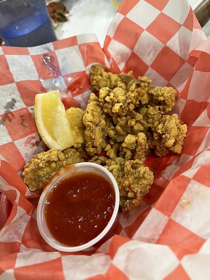 Fried oysters that crackle with each bite, served with cocktail sauce and lemon—proof that simplicity often delivers the most profound satisfaction.