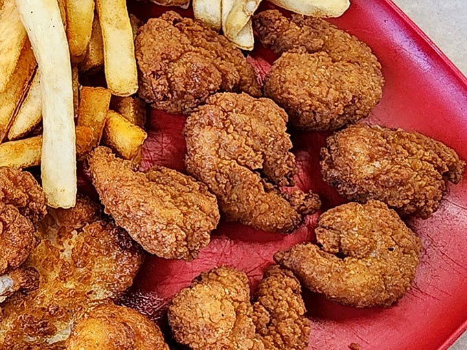 Golden-fried shrimp nestled in their paper cradle – crispy treasures that snap between your teeth before melting into sweet satisfaction.