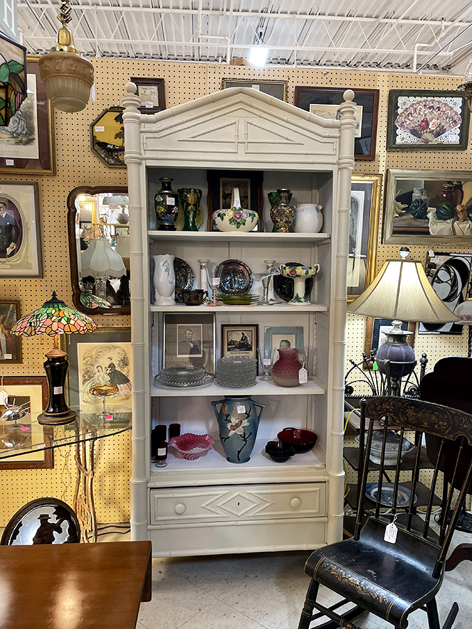 This elegant white bookcase isn't just furniture – it's a stage where porcelain, glassware, and memories perform their silent theater of nostalgia.