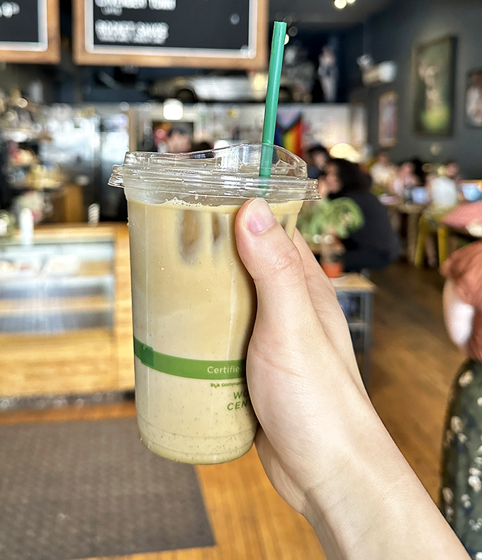 Someone's holding liquid gold—an iced latte that promises to transform your afternoon slump faster than Clark Kent in a phone booth.