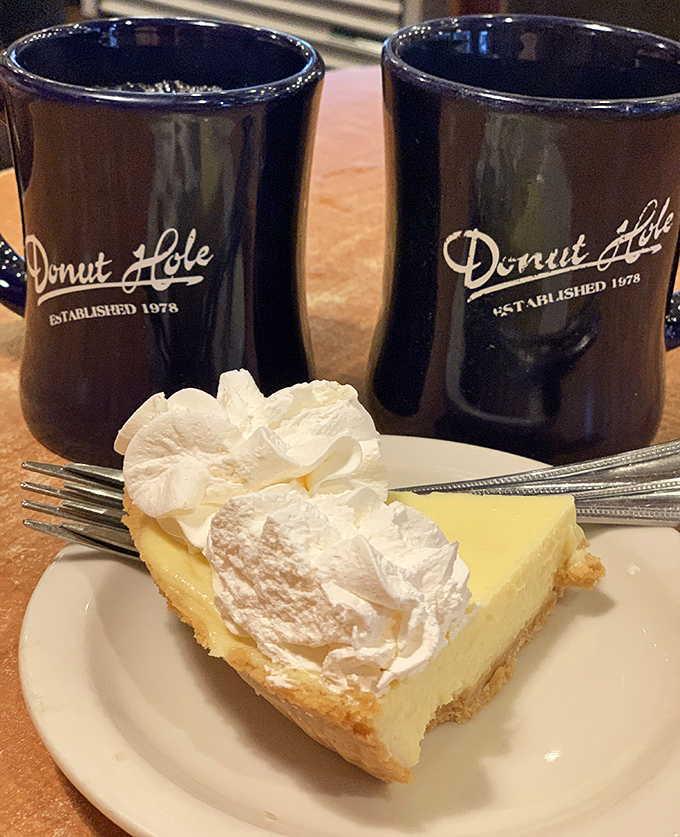 Key lime pie with clouds of whipped cream flanked by signature navy blue mugs—Florida's official "I deserve this" afternoon indulgence.
