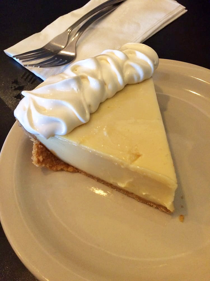 Key lime pie that finds the perfect balance between sweet and tart. That dollop of whipped cream isn't decoration—it's the perfect dance partner.